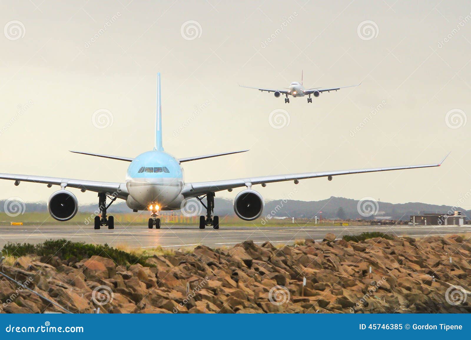Airbus A330 on Runway with Second Plane Landing Behind Stock Image ...