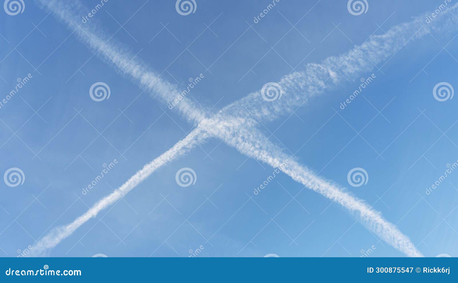 Aircraft Contrails Crossing and Forming an X in a Blue Sky Stock Image ...