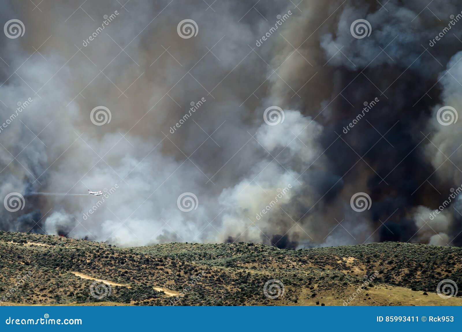 Aircraft Flying through the Dense White Smoke Rising from the Raging ...