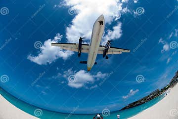 Aircraft flying over beach stock photo. Image of angle - 14458168