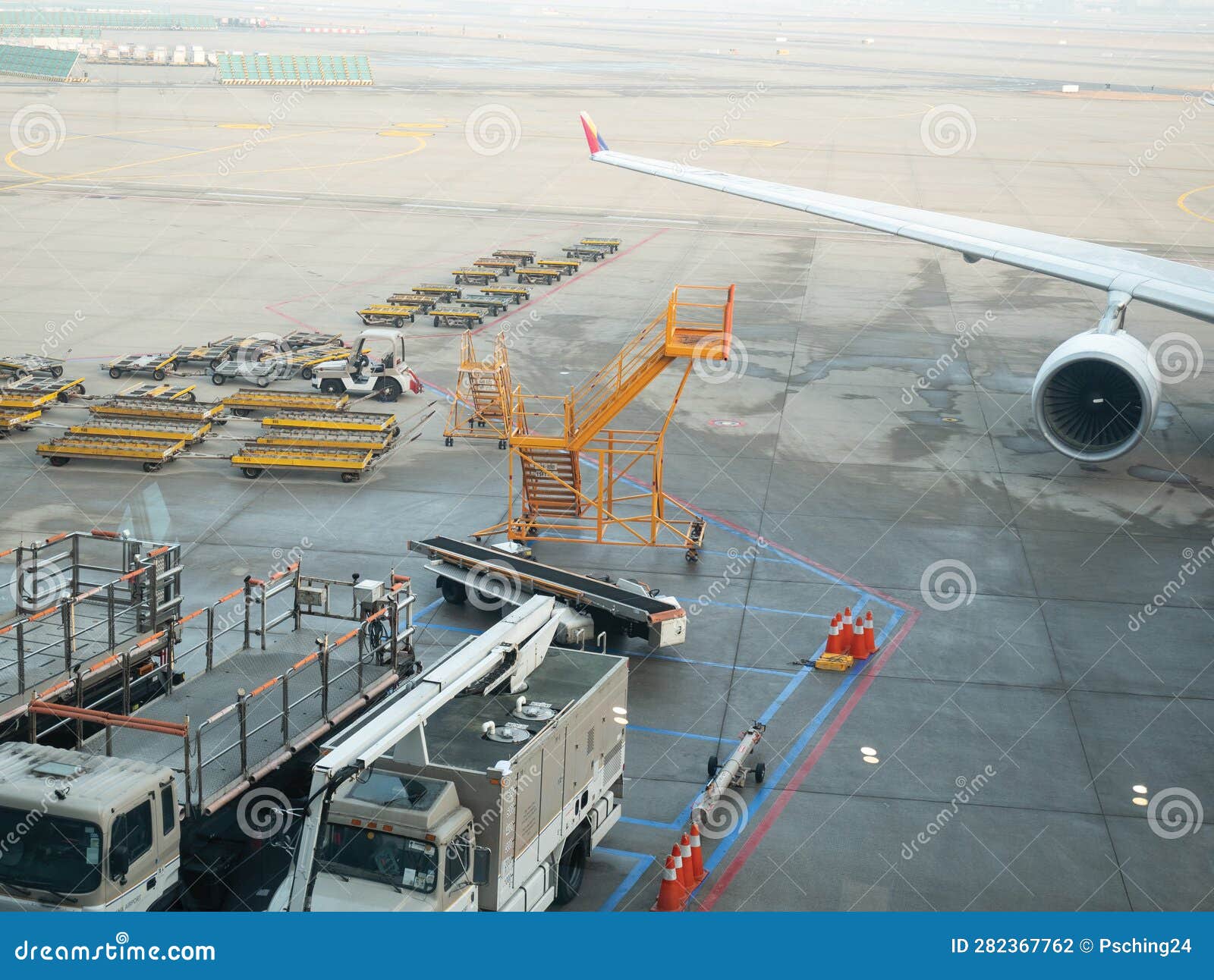 Ground Handling Of A White Passenger Aircraft At The Boarding Bridge On ...