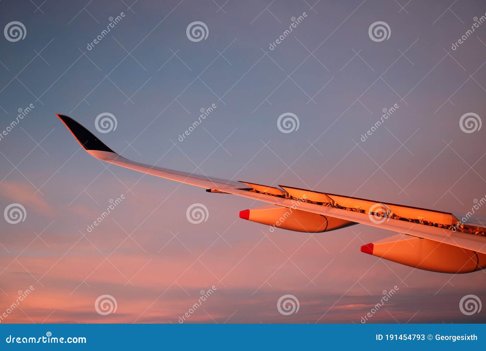 Aircraft Wing Flaps Up Blue Sky Pink Clouds Below Stock Image - Image ...