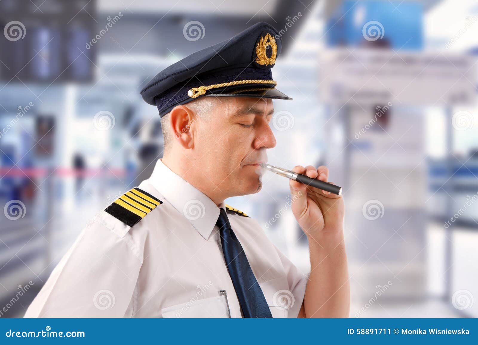 Airline Pilot with E-cigarette Stock Image - Image of airport, airliner ...