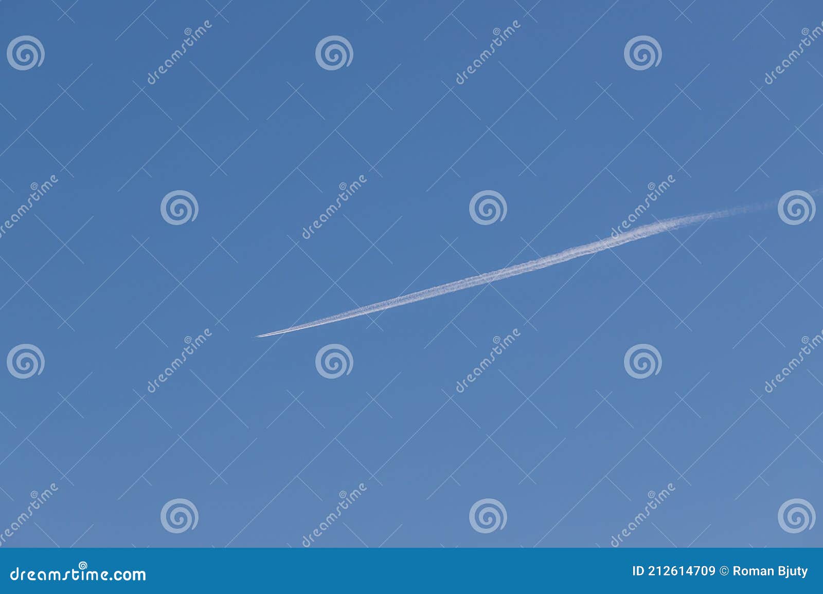 Airliner Flies High in the Sky. There is a Line Behind the Plane Stock ...