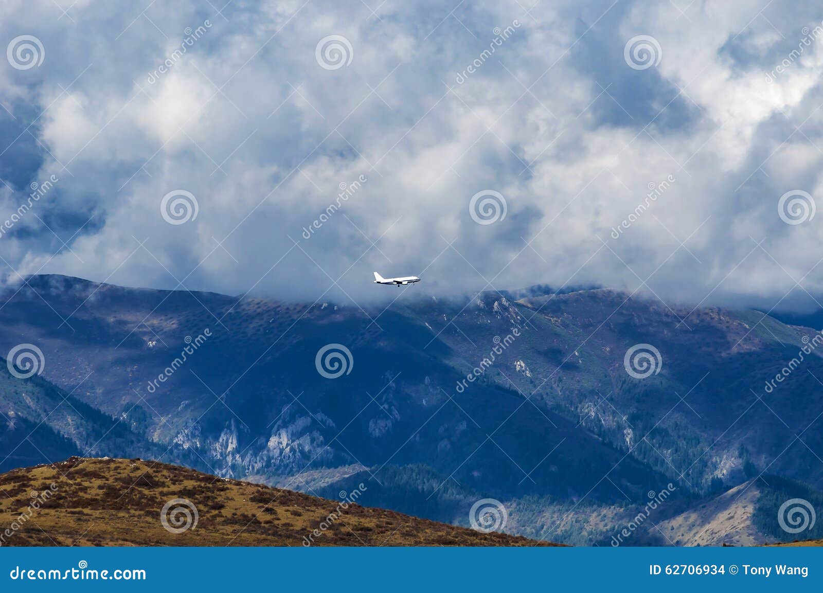An Airliner Flying in the Valley. Stock Photo - Image of yellow, blue ...
