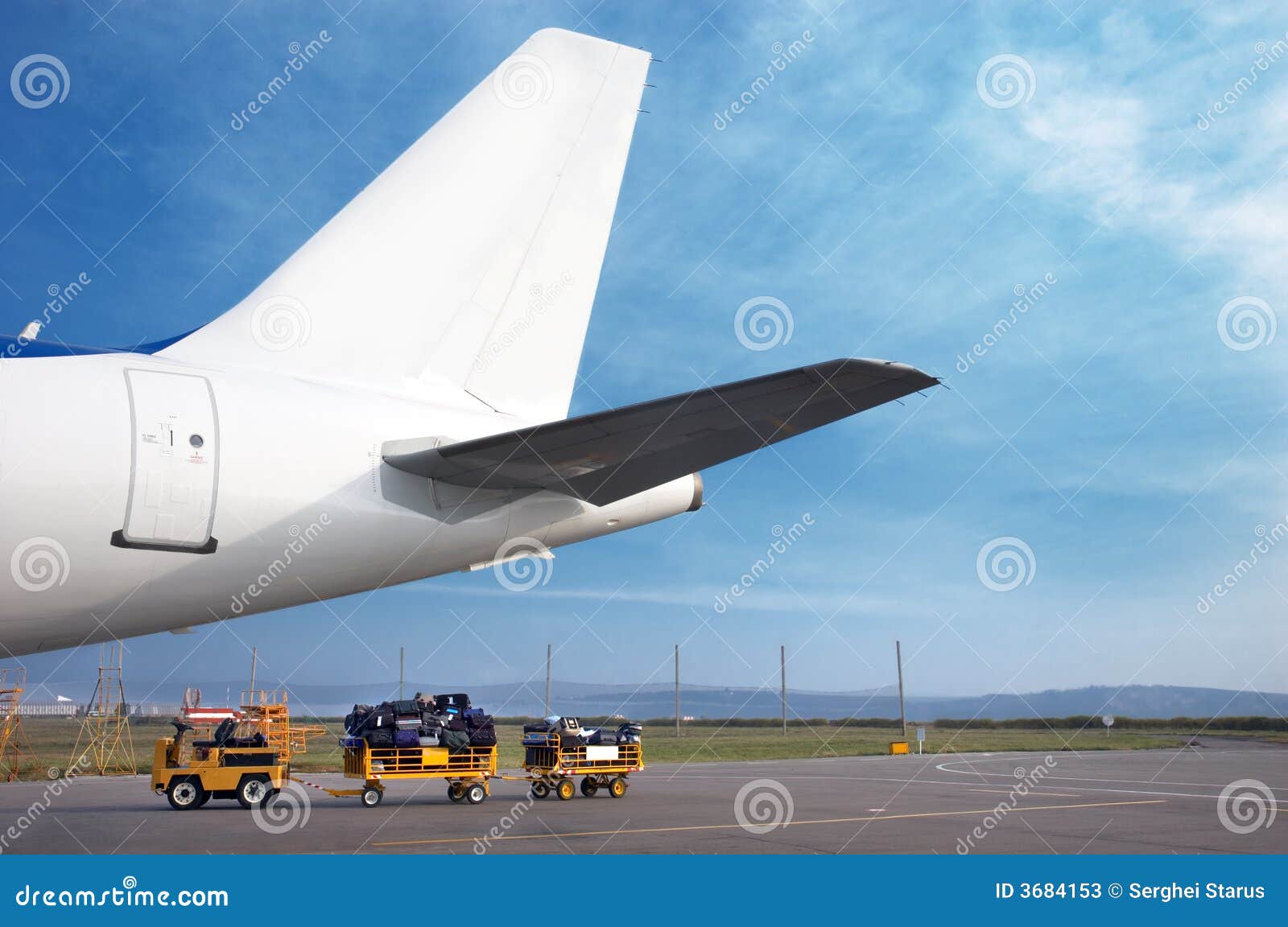 Airplain Tail and Luggage Cart Stock Image - Image of aerospace ...