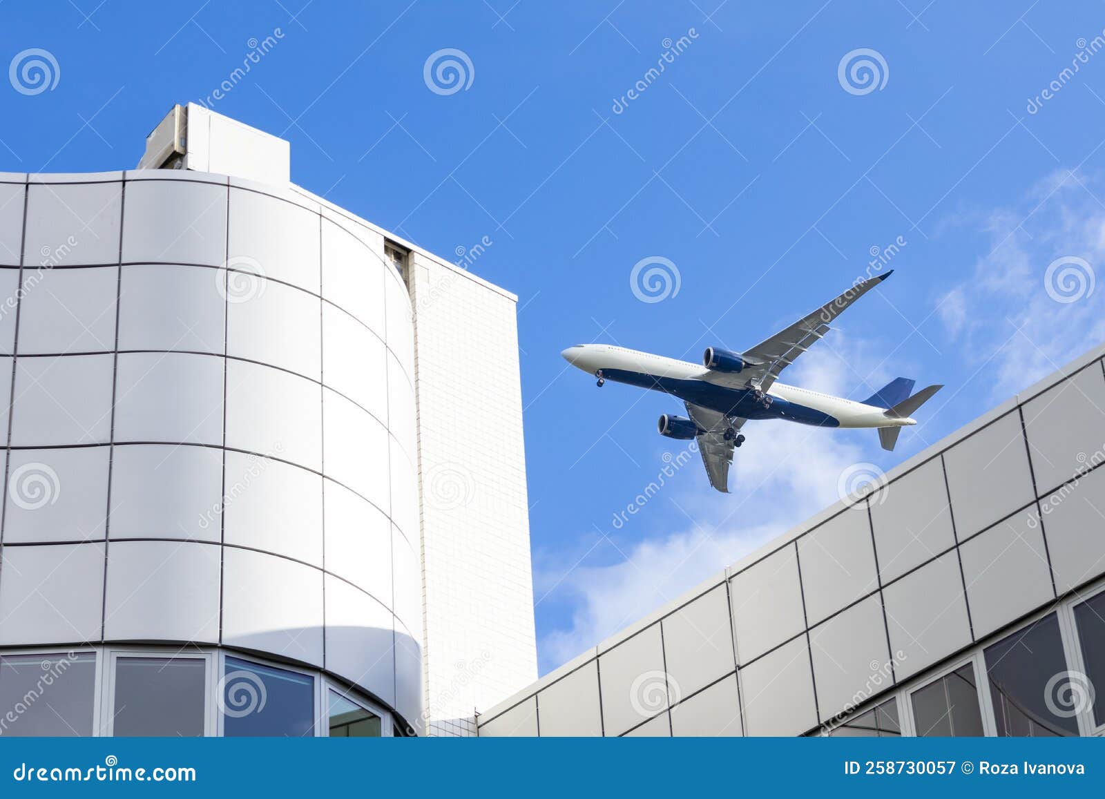 Airplane in Blue Sky with Light Clouds Over the House Stock Image ...