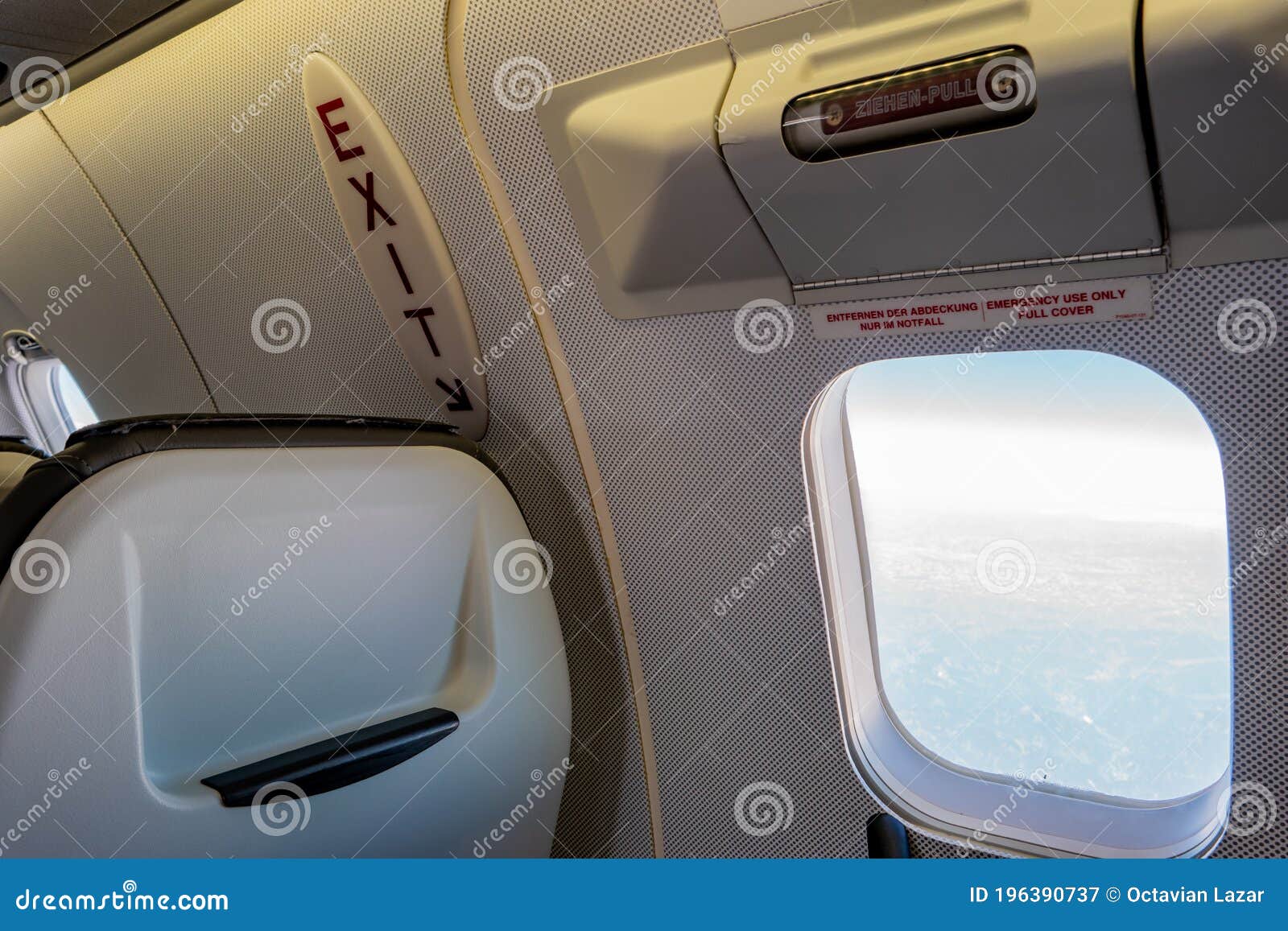 Airplane Cabin Passenger Seat Next To Emergency Exit with Signs and ...