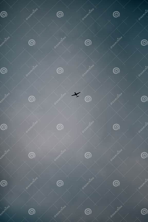 An airplane in a dark sky stock image. Image of airplane - 147182337