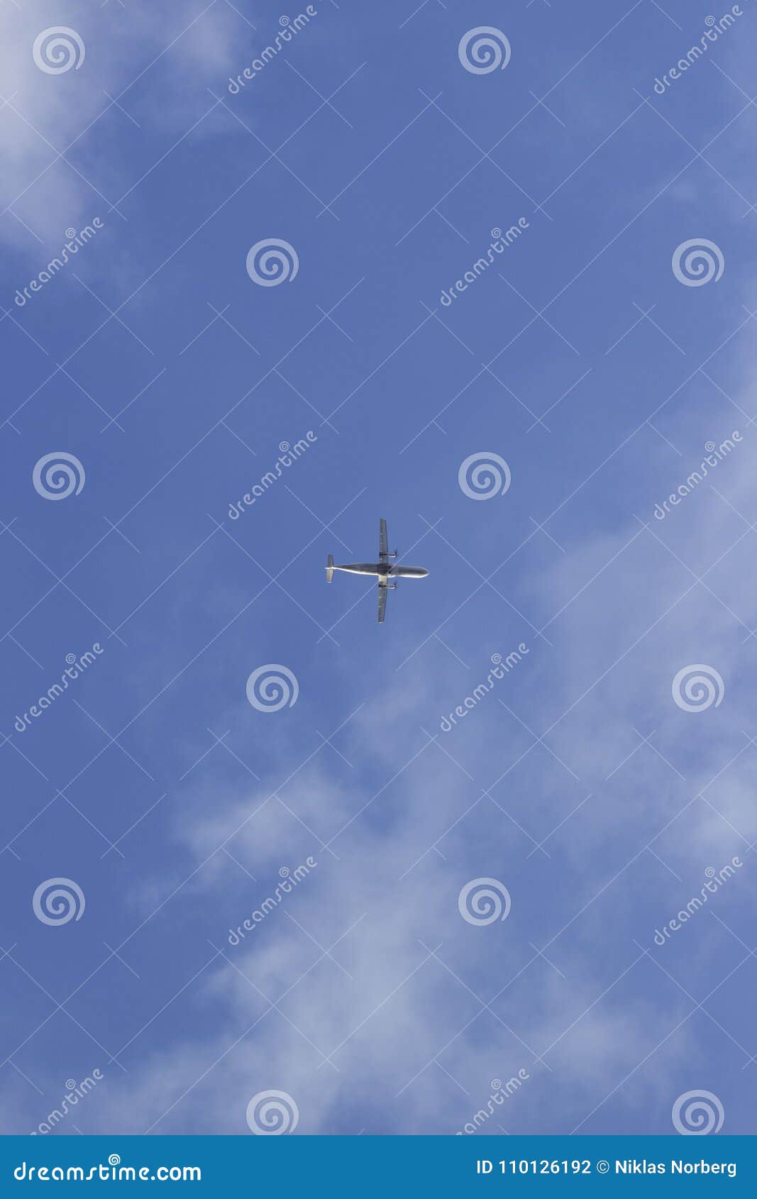 Airplane in Distance, Centered in a Blue Sky with Light Clouds. Stock ...