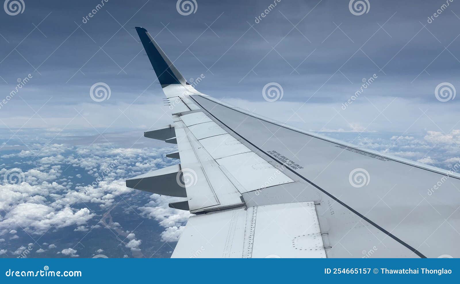 Airplane Flight. Wing of an Airplane Flying Above the Clouds Stock ...