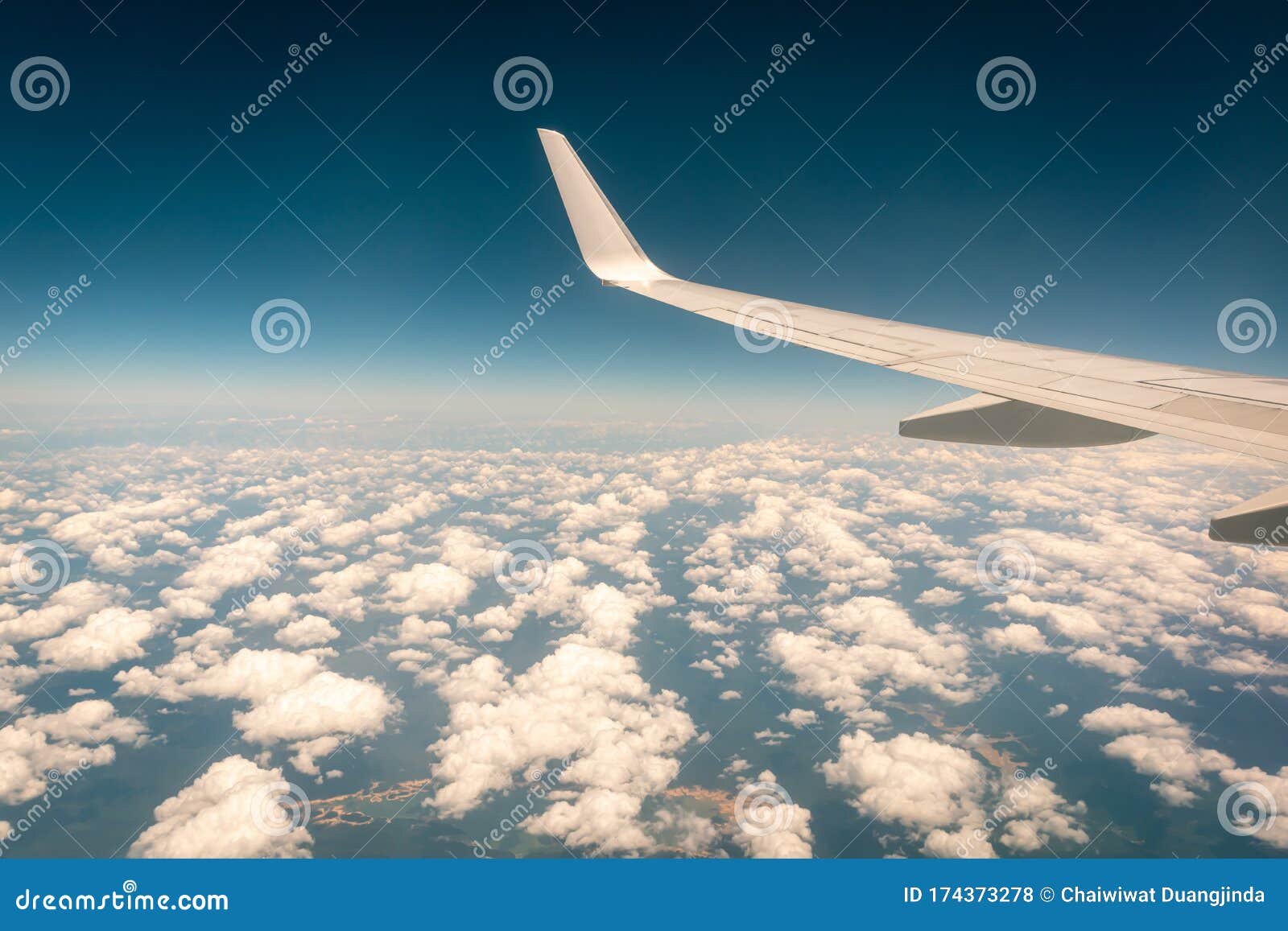 Airplane Flying Above the Clouds at Sunset Stock Photo - Image of plane ...