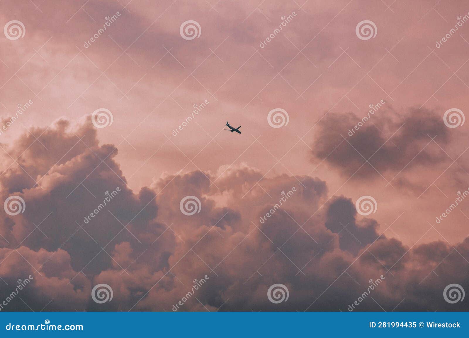 Airplane Flying in a Beautiful Sunset Sky with Wispy Clouds in the ...