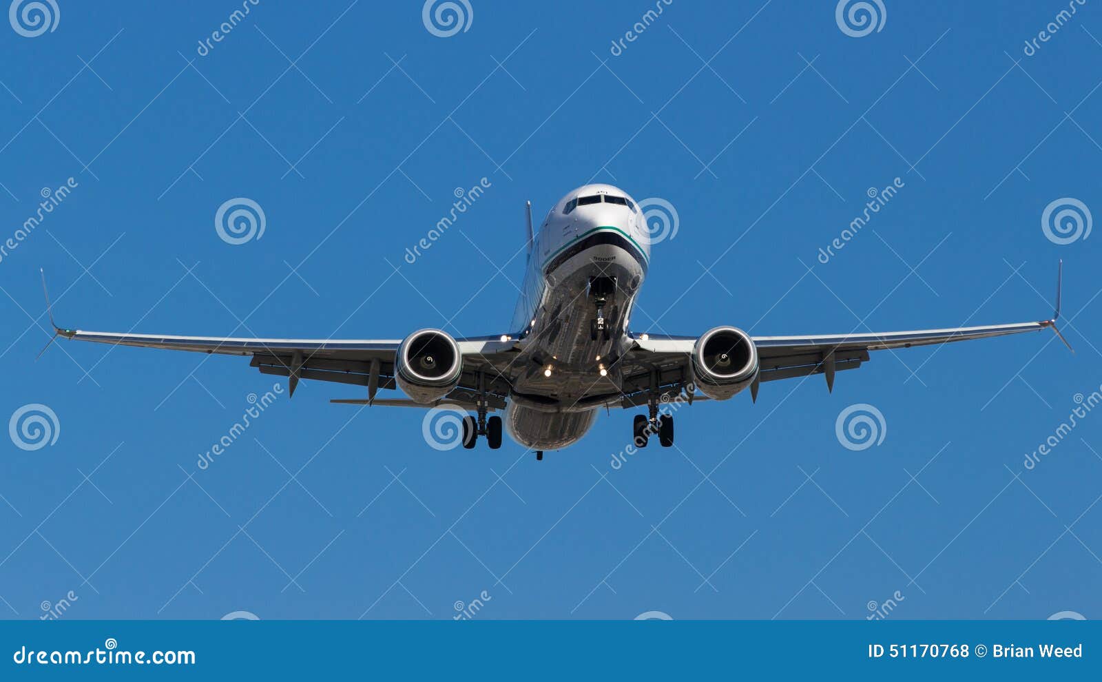 Airplane Flying Down for Landing Stock Photo - Image of wheels, urban ...