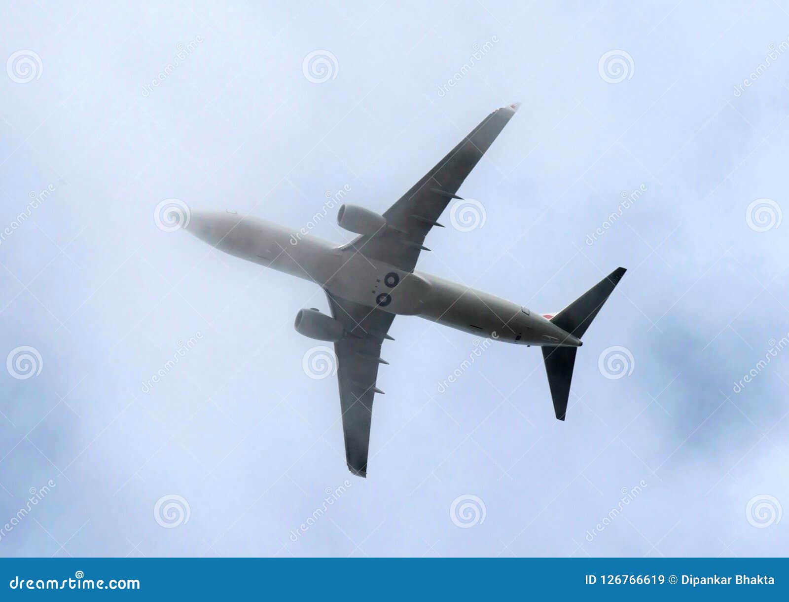 Airplane Flying High through Dense Clouds in Blue Sky Stock Image ...