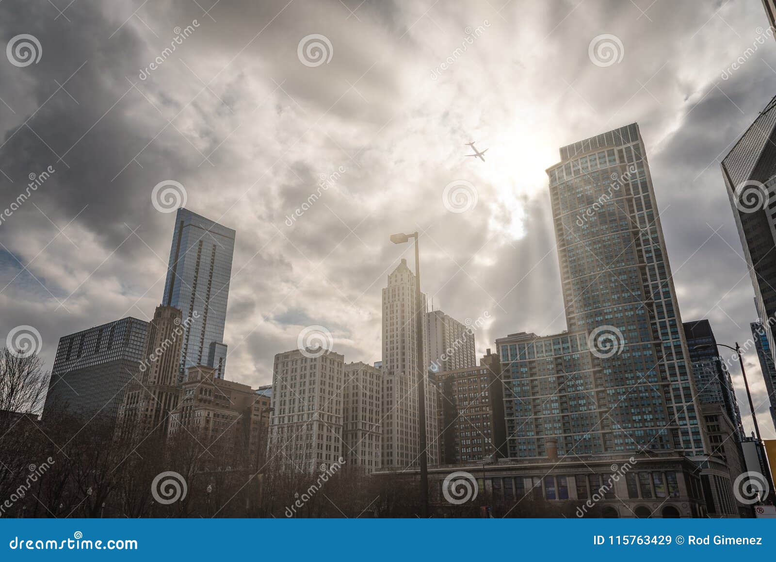 Airplane Flying Over Downtown Chicago with Sun Rays Stock Image - Image ...