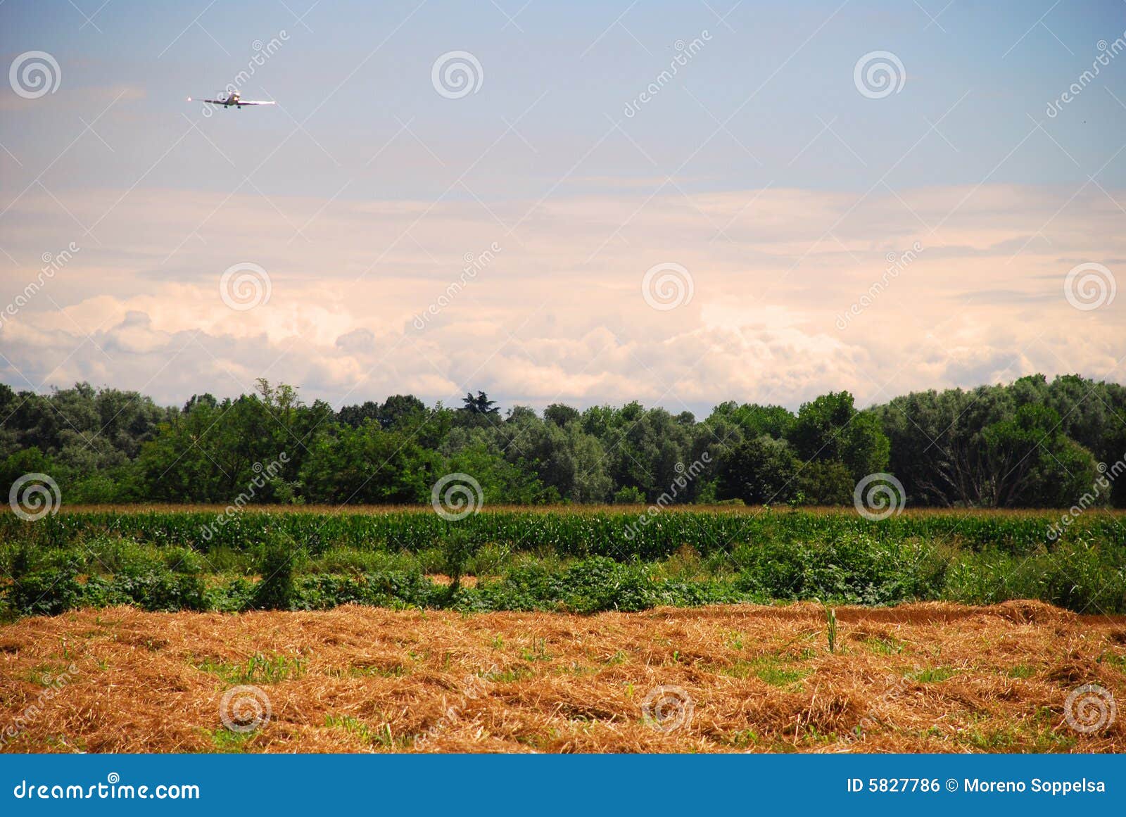 Airplane flying over field stock photo. Image of approaching - 5827786