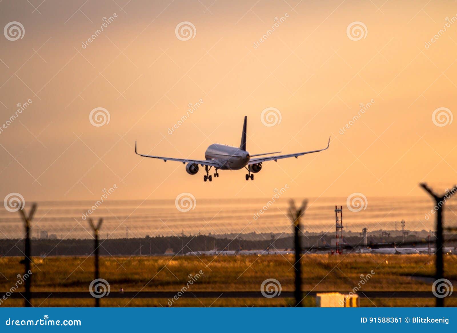 Airplane landing at sunset stock image. Image of land - 91588361