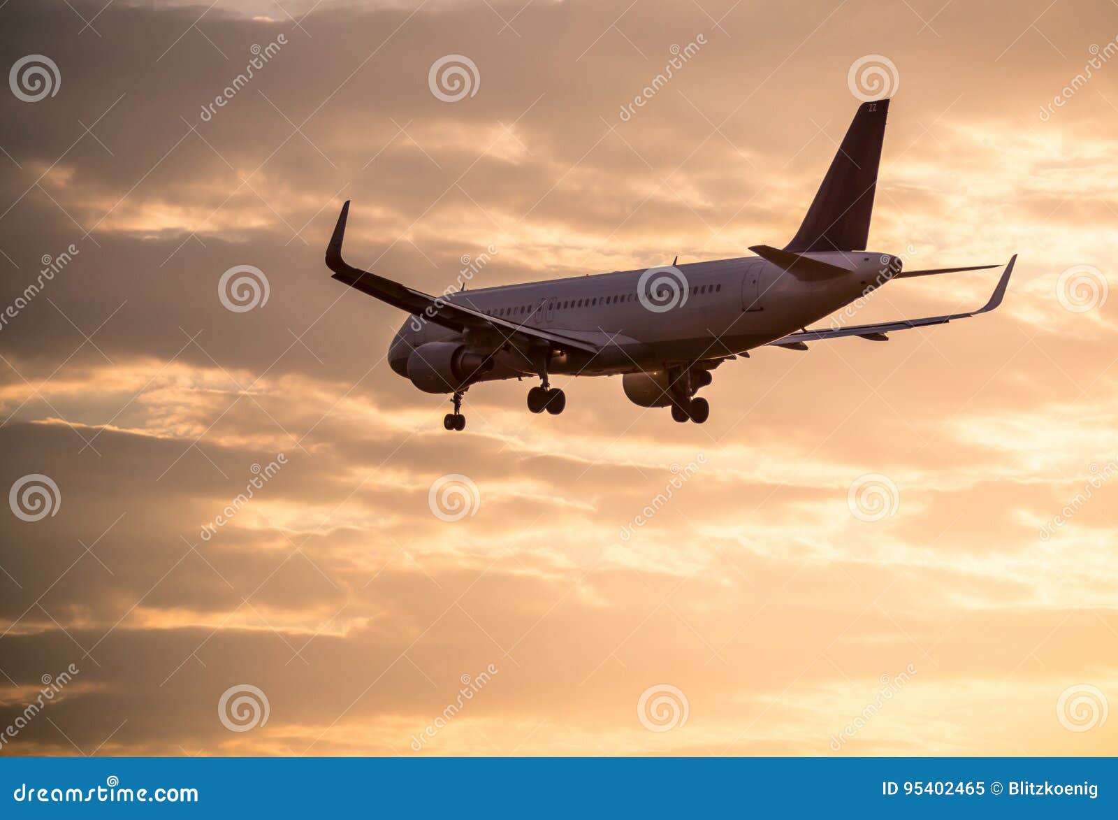 Airplane landing at sunset stock image. Image of sunset - 95402465