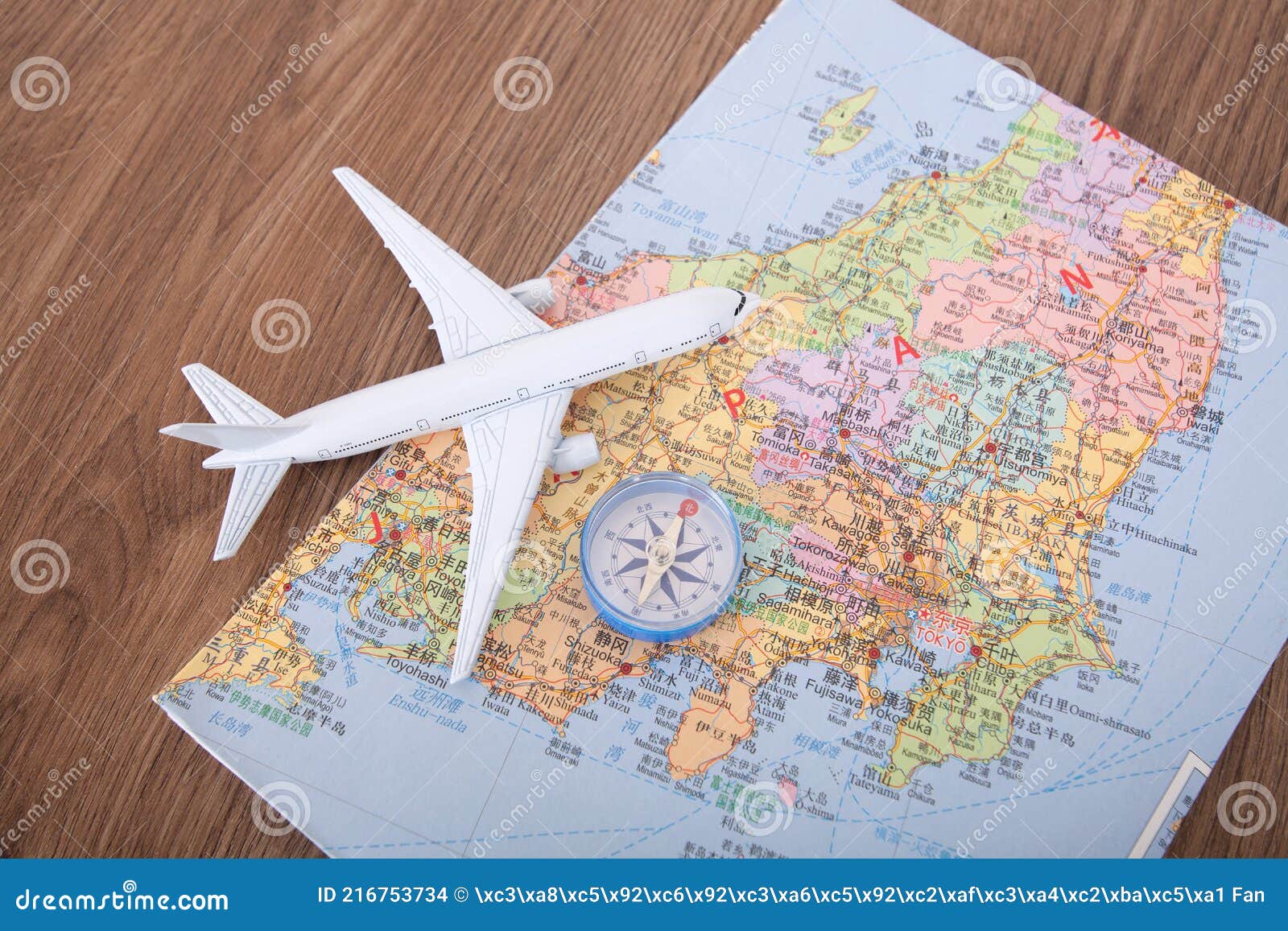 An Airplane Model and a Compass on a Paper Japan Travel Map Stock Photo ...