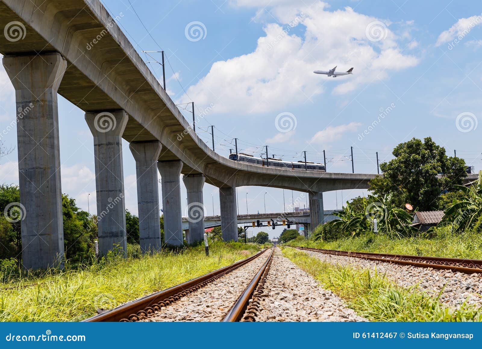 Airplane Over Skytrain and Train Stock Image - Image of travel, transit ...