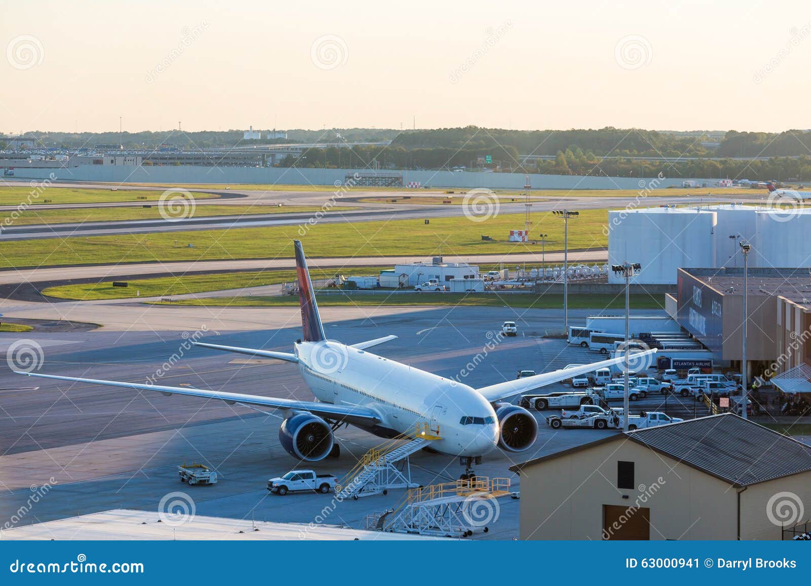 Airplane Parked in Evening Light Stock Image - Image of ground, runway ...