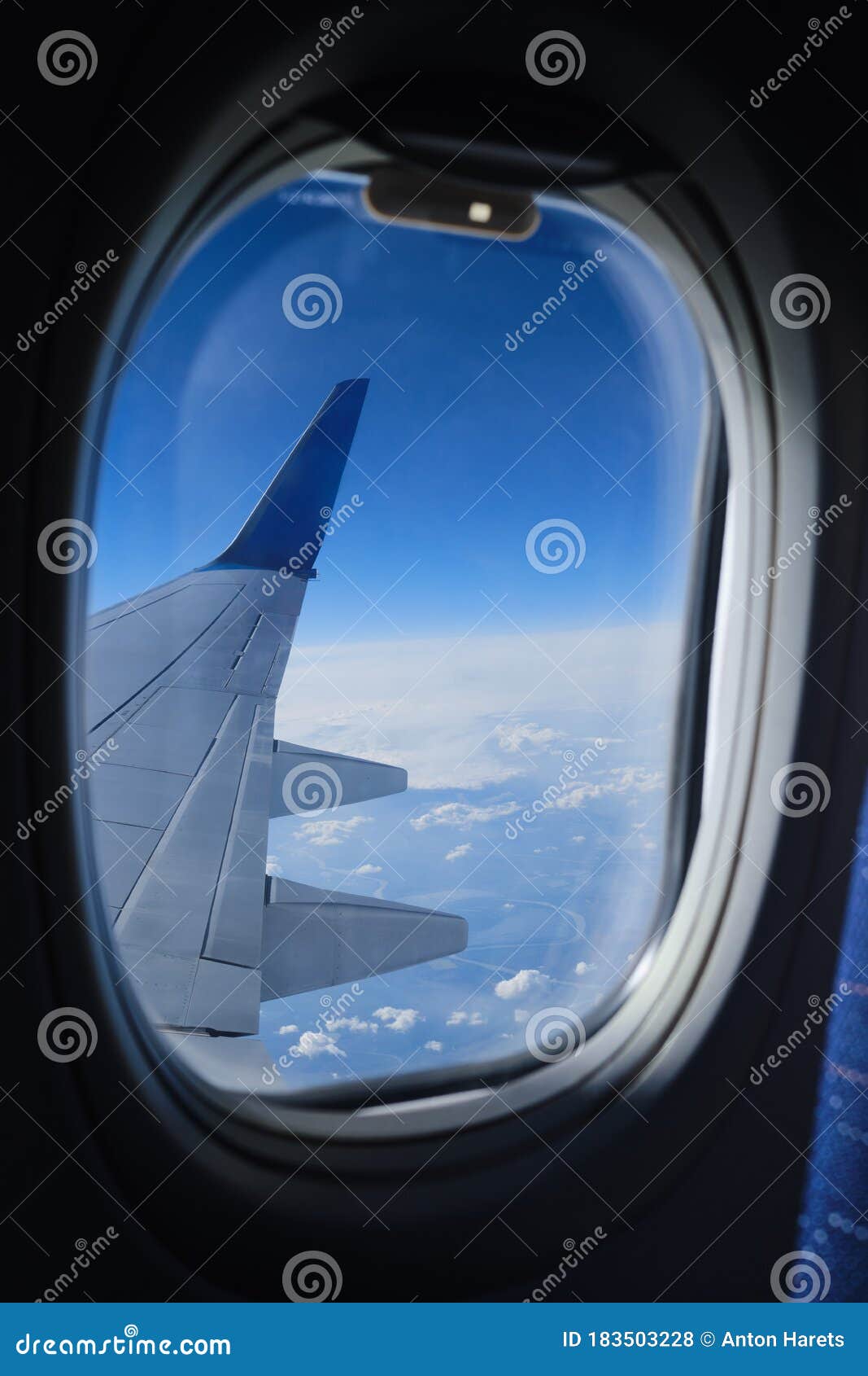 Airplane Window View on the Clouds and Blue Sky Horizon. Plane Wing ...