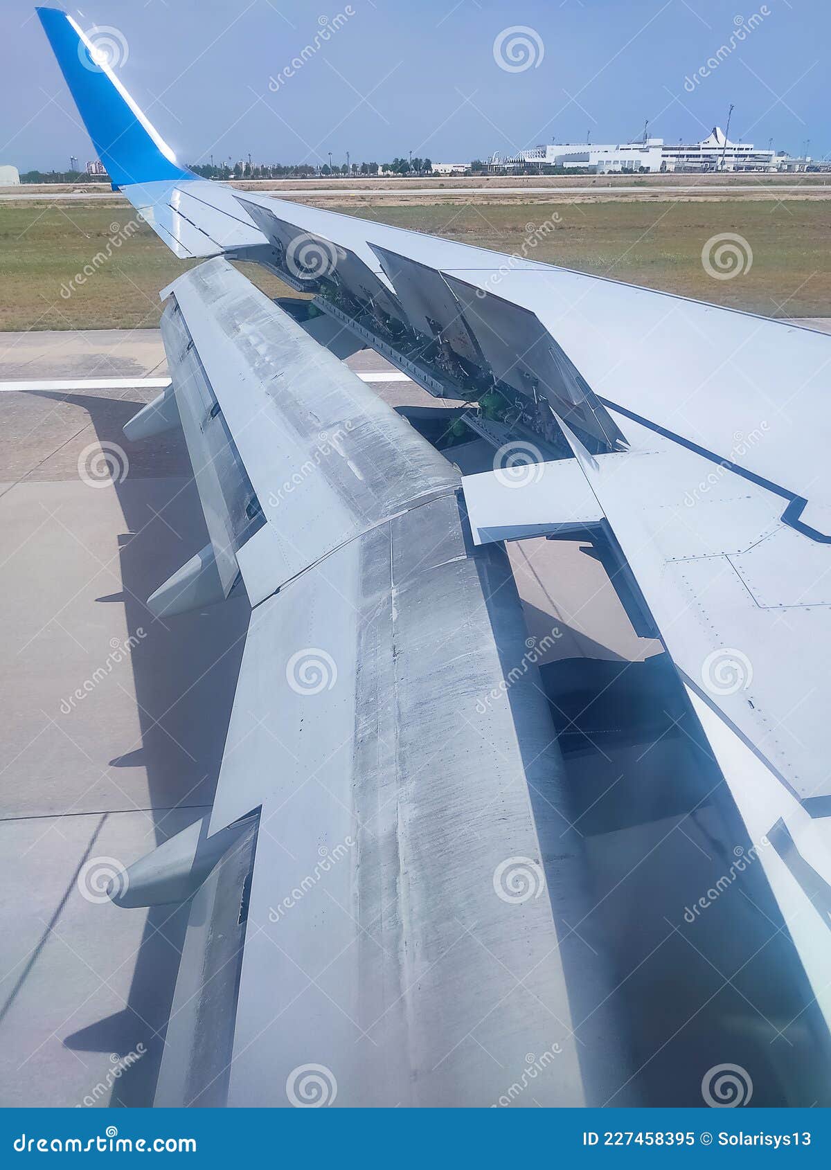 An Airplane Window View Of Wing And Flaps After Landing. Royalty-Free ...