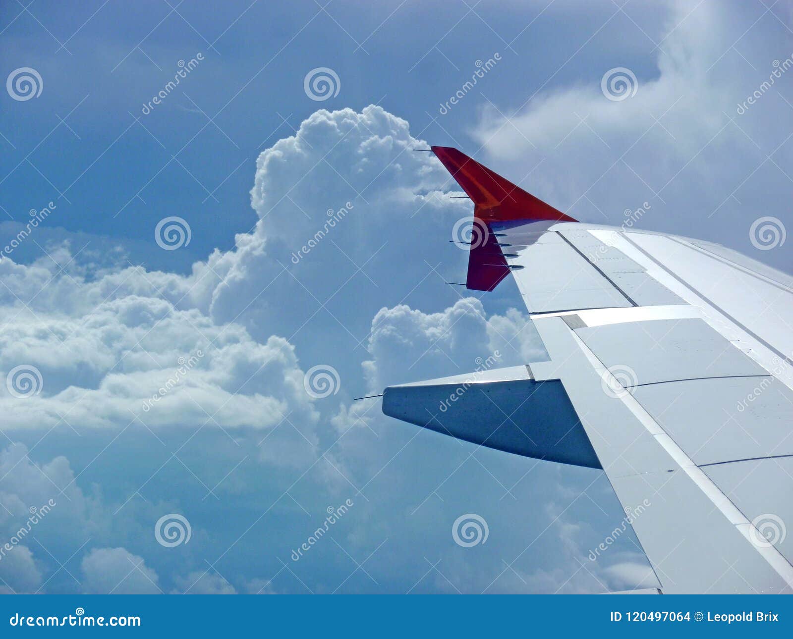 Airplane wing and clouds stock photo. Image of wing - 120497064