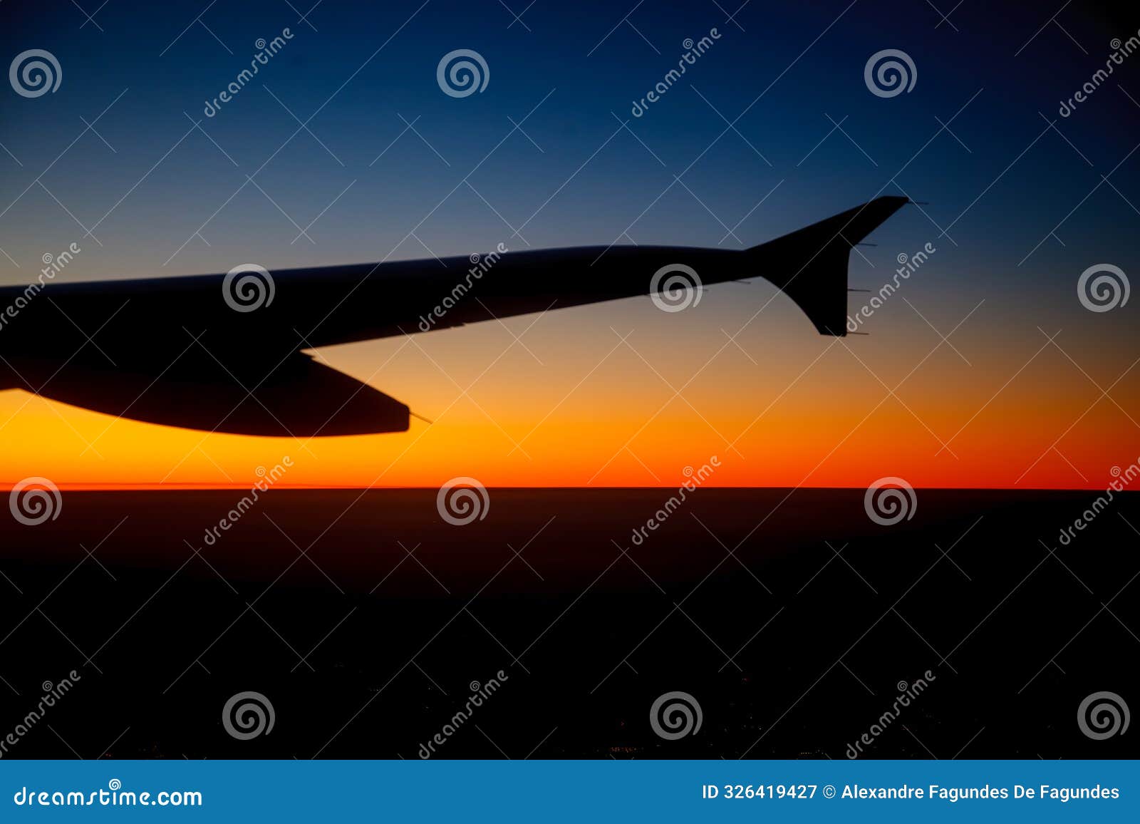 Airplane Wing and the Colors of Sunset or Sunrise Stock Image - Image ...