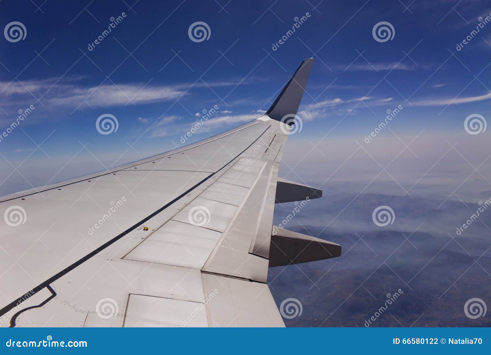 Airplane Wing in Flight stock photo. Image of looking - 66580122
