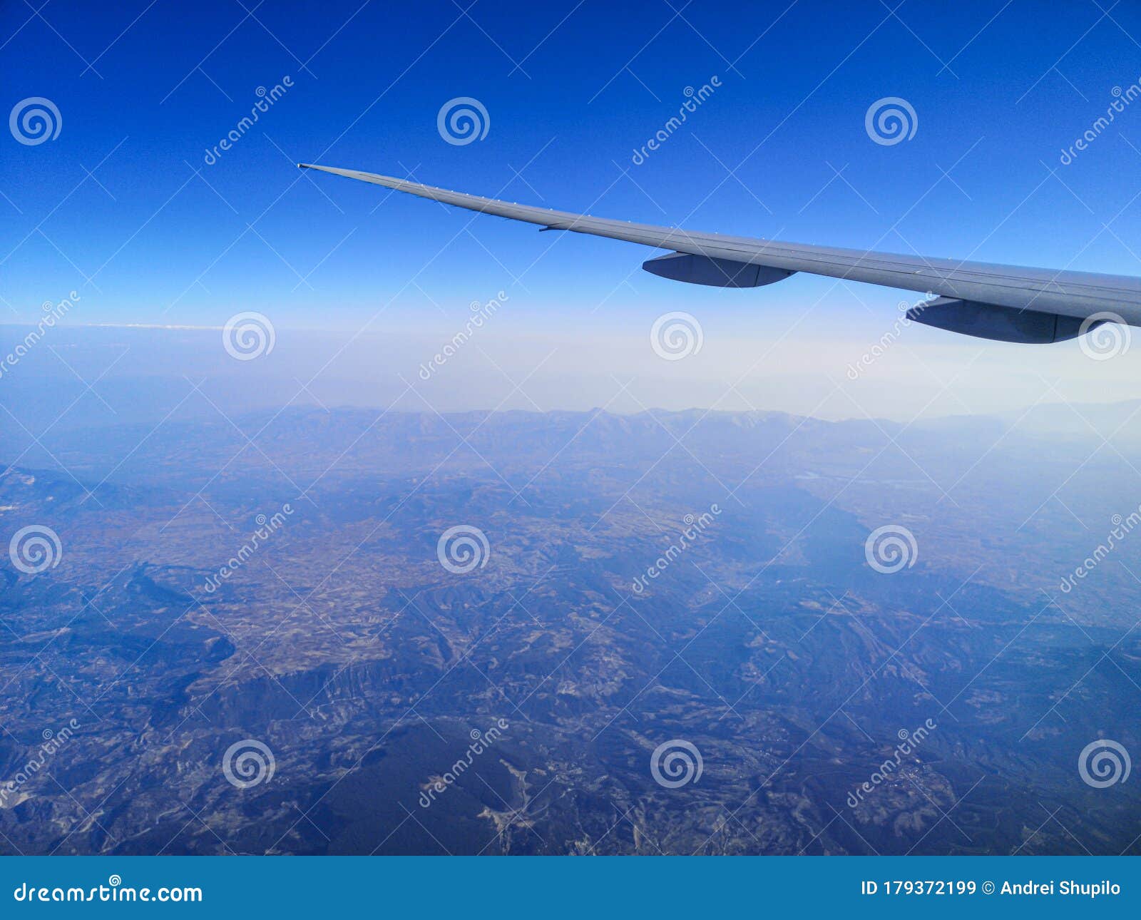 Airplane wing in flight stock image. Image of horizon - 179372199