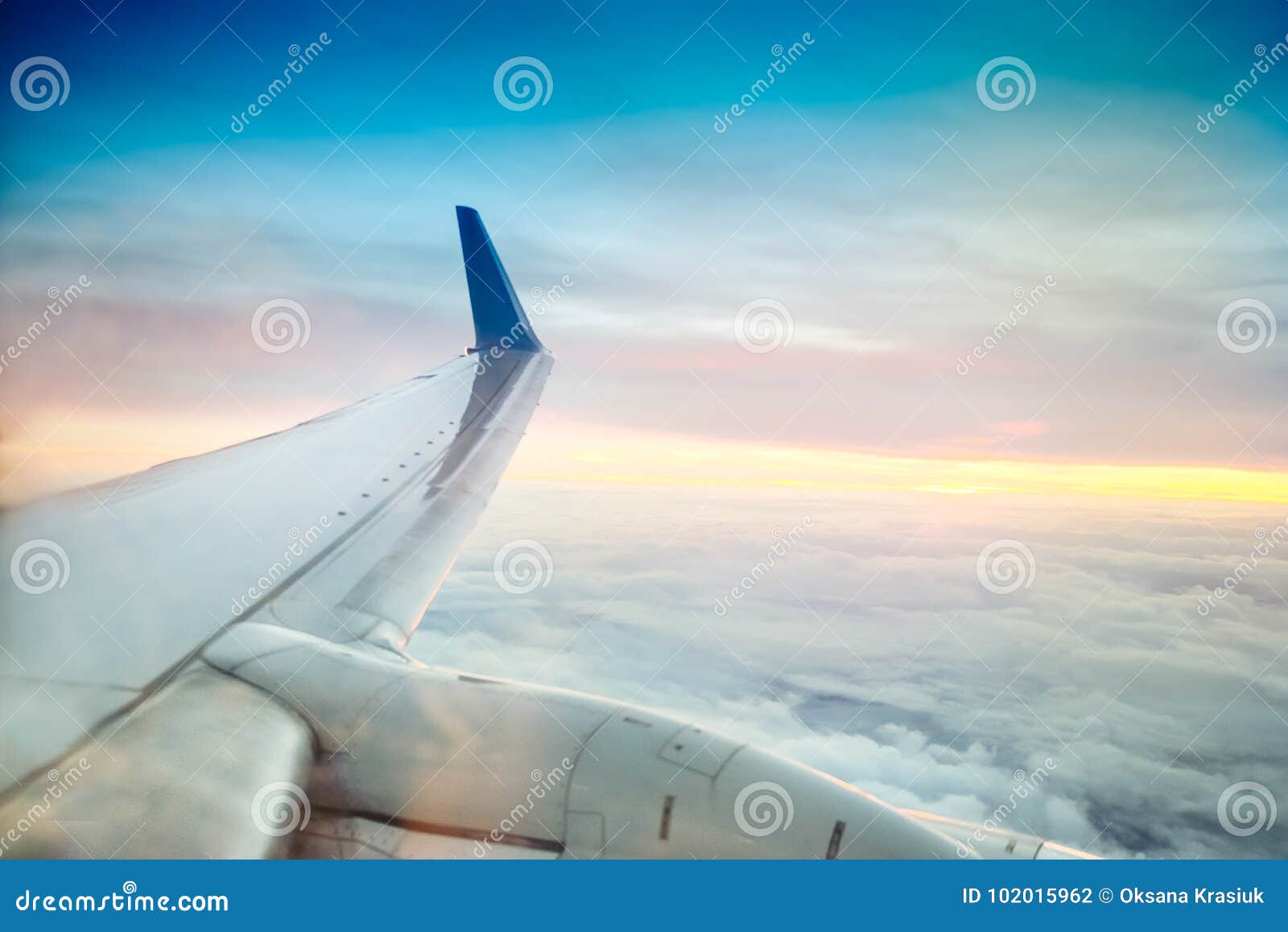 Airplane Wing Flying Above Clouds on the Sunset. Selective Focus Stock ...