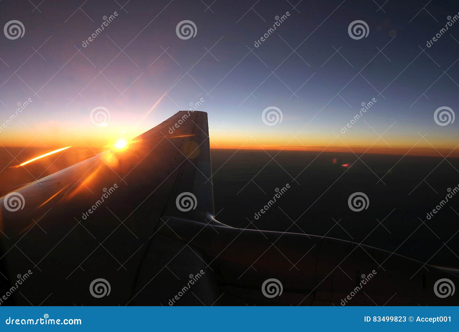 Airplane Wing Flying Over Clouds when View from Window at Sunset Stock ...