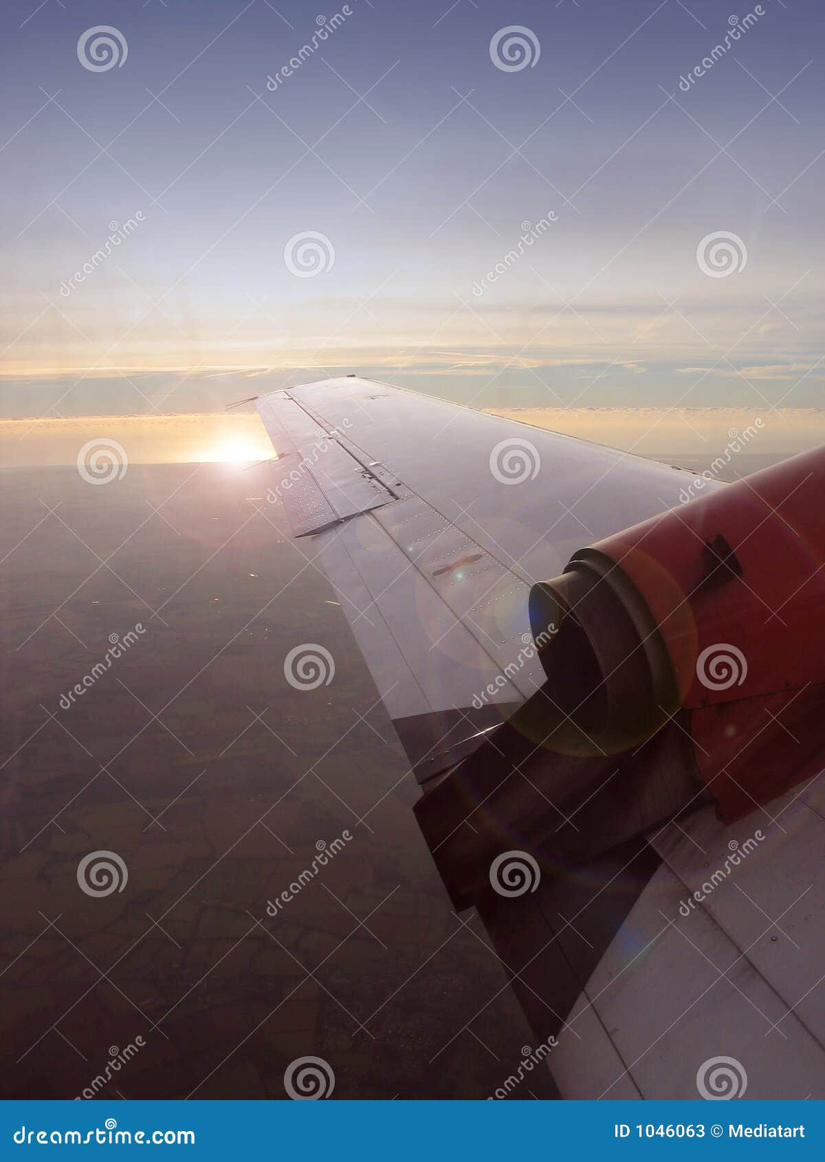 Airplane Wing with Sun Flare Stock Image - Image of wing, flying: 1046063