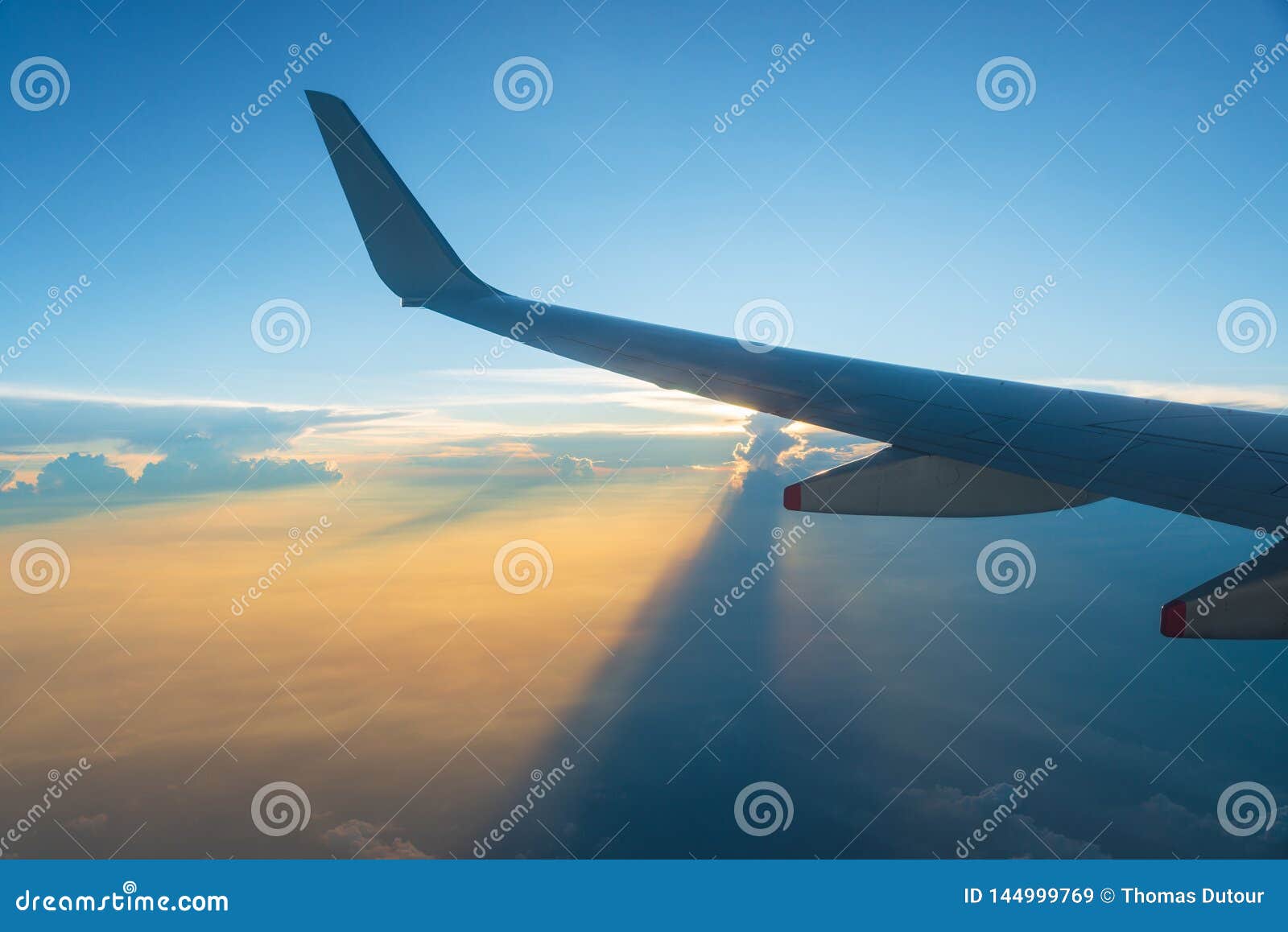 Airplane wing at sunset stock image. Image of sunset - 144999769