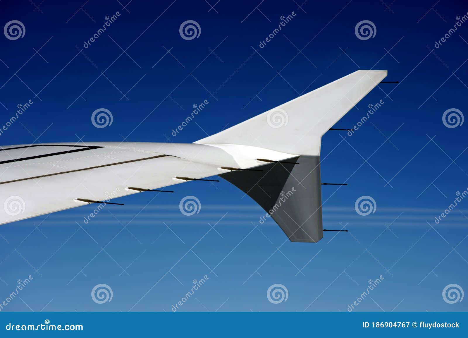 Airplane Wing Tip on Blu Sky Stock Image - Image of industry, stopped ...