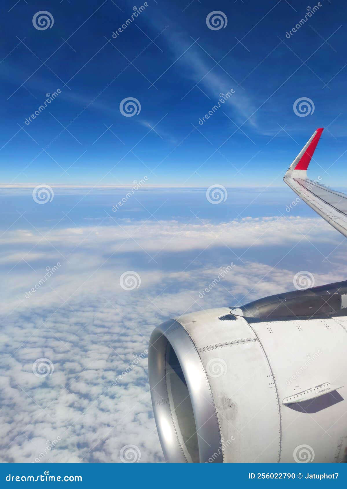 Airplane Wing through the Window Aircraft during Flight with a Blue Sky ...