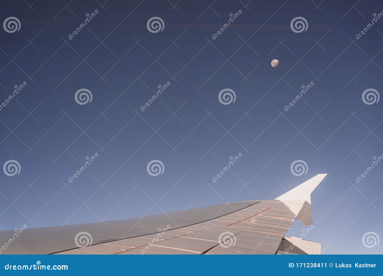 Airplane Wing through the Airplane Window with the Moon in the ...