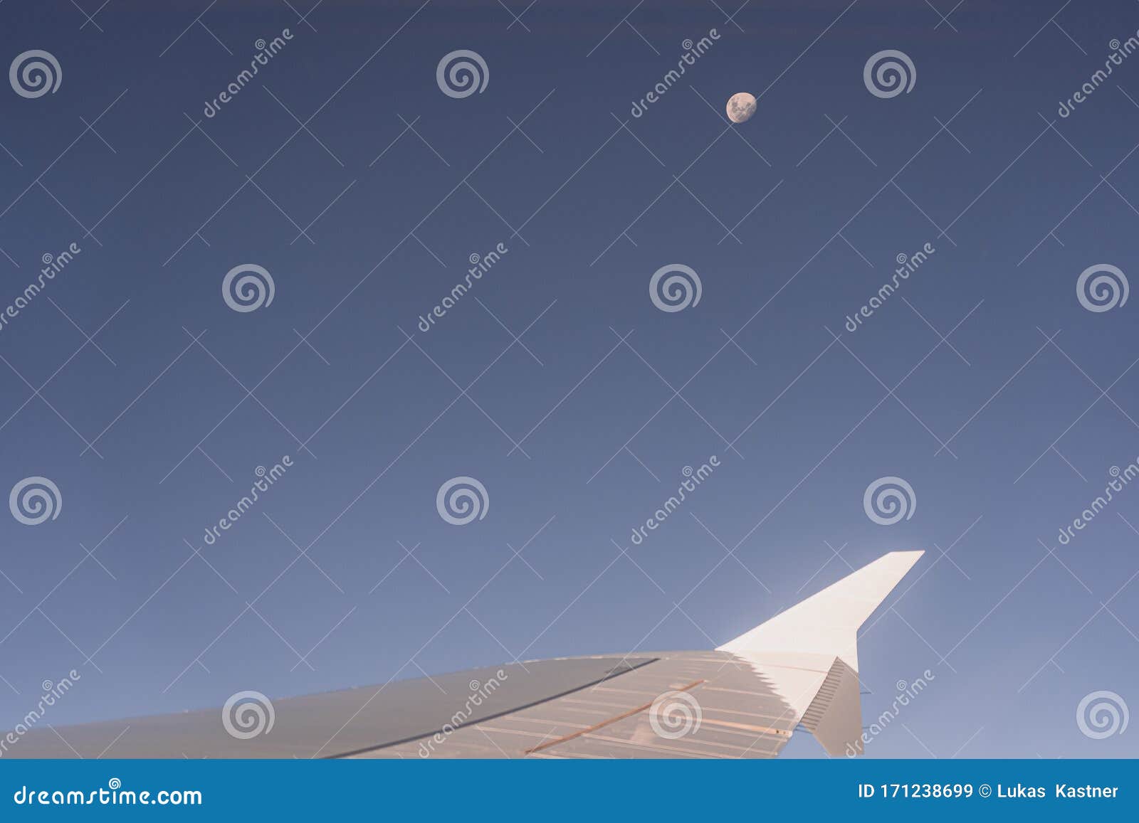 Airplane Wing through the Airplane Window with the Moon in the ...