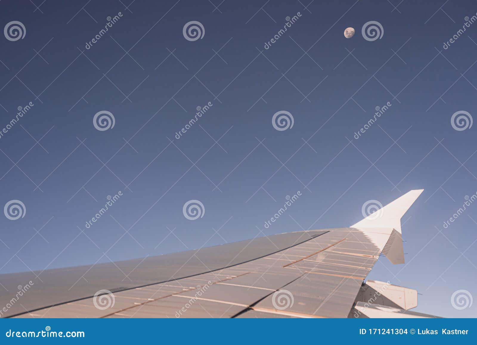 Airplane Wing through the Airplane Window with the Moon in the ...