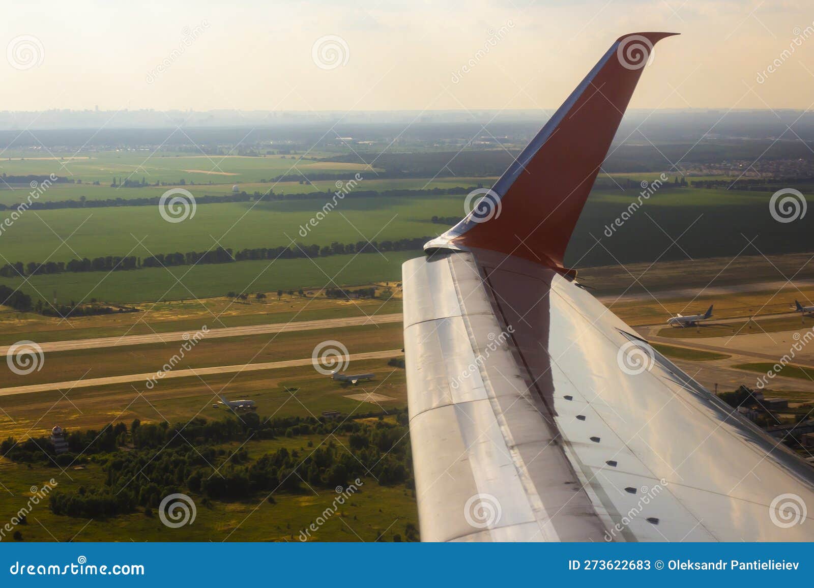 An Airplane Wing with a Wingtip during a Flight Over the Fields Stock ...