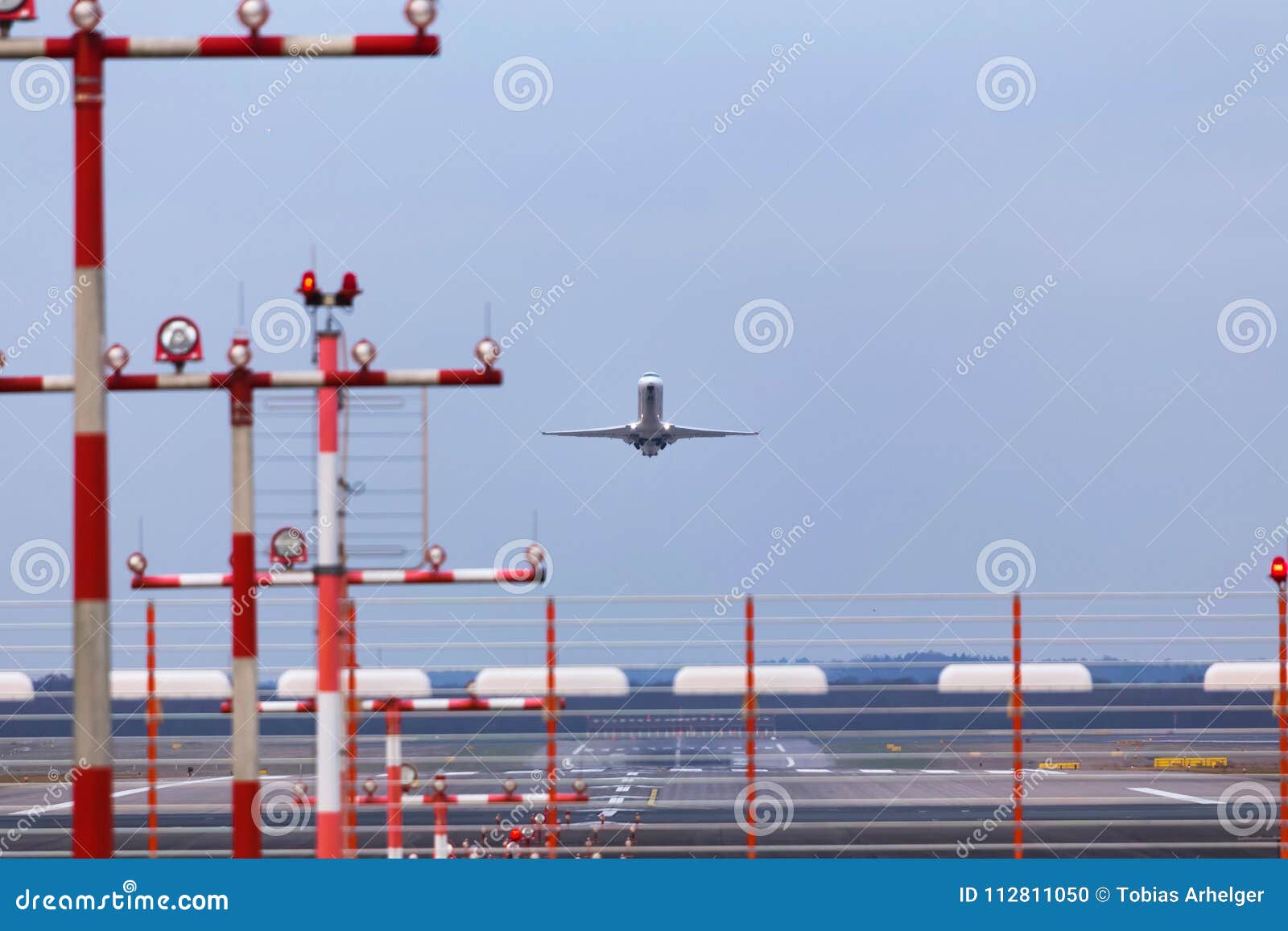 Airport Beacons with Starting Airplane in the Daylight Stock Photo ...