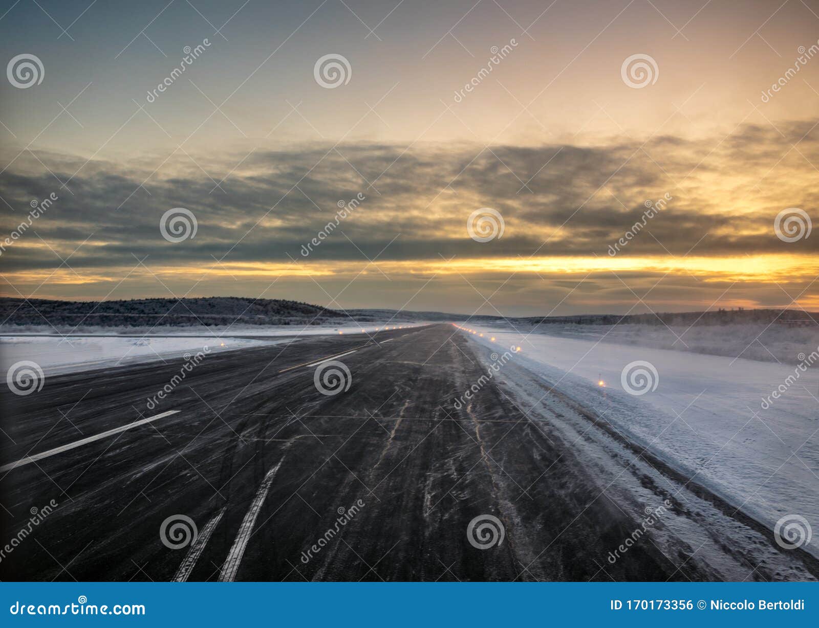 Airport Runway at Dawn Surrounded by Snow Stock Photo - Image of path ...