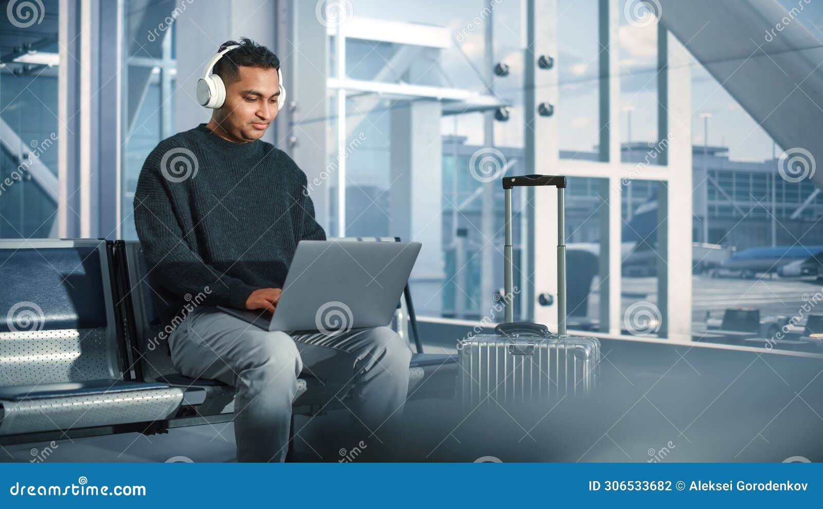 Airport Terminal: Businessman Uses Laptop Computer, Listents To Musics ... Airport Terminal: Businessman Uses Laptop Computer, Listents To Musics ...