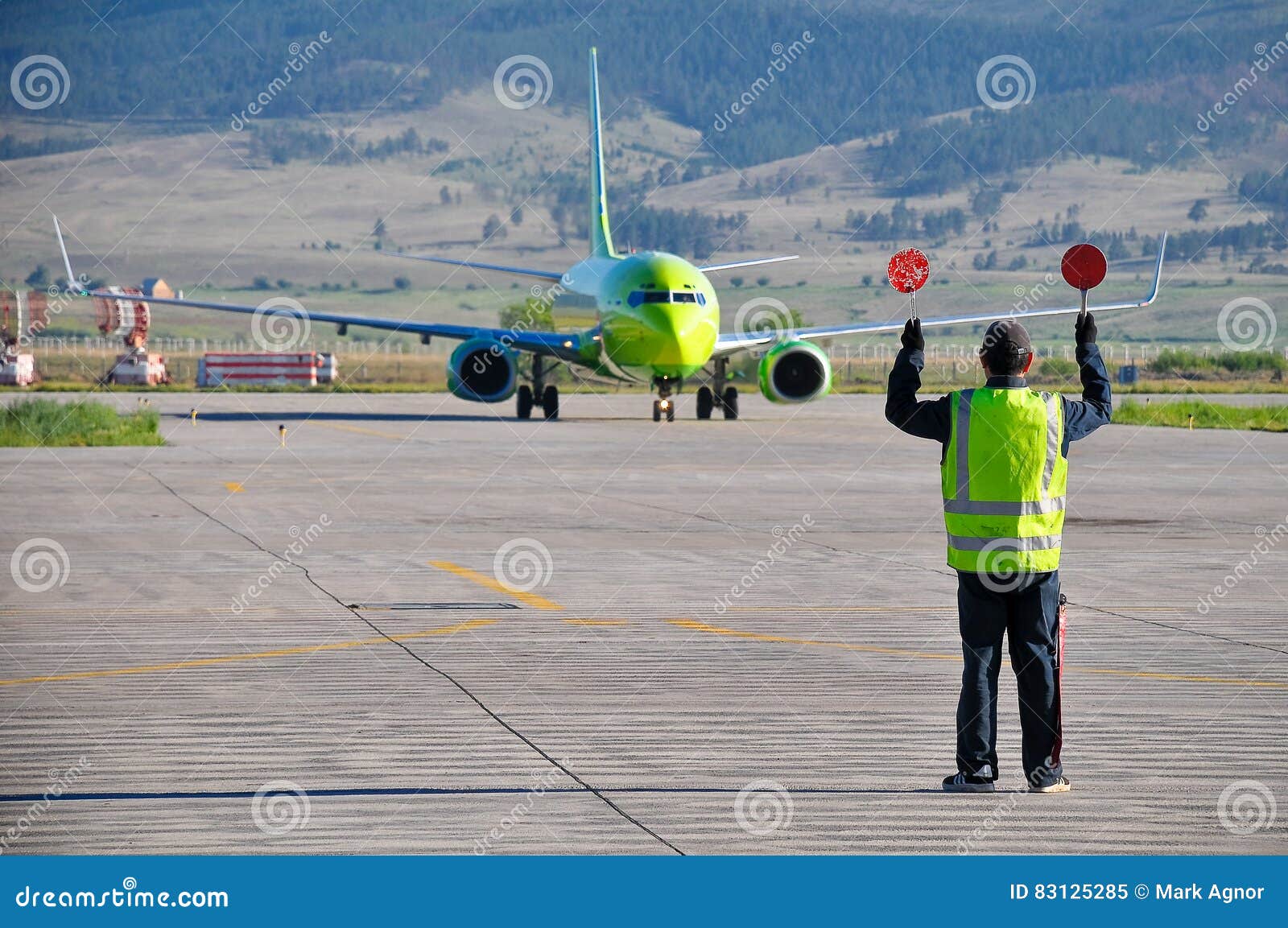 Airport worker directing stock image. Image of carrier - 83125285