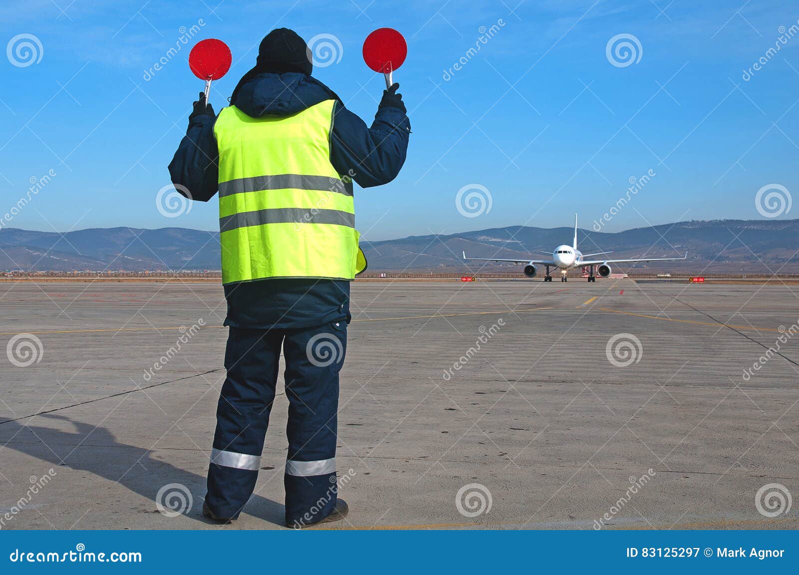 Airport worker directing stock image. Image of departure - 83125297