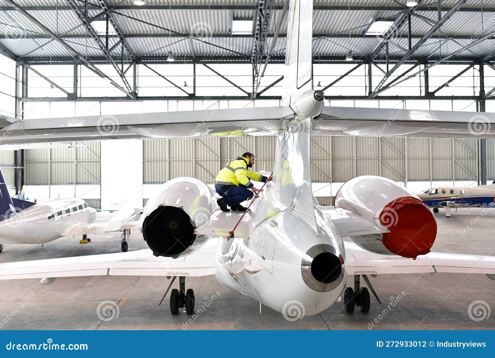 Airport Workers Check an Aircraft for Safety in a Hangar Stock Photo ...