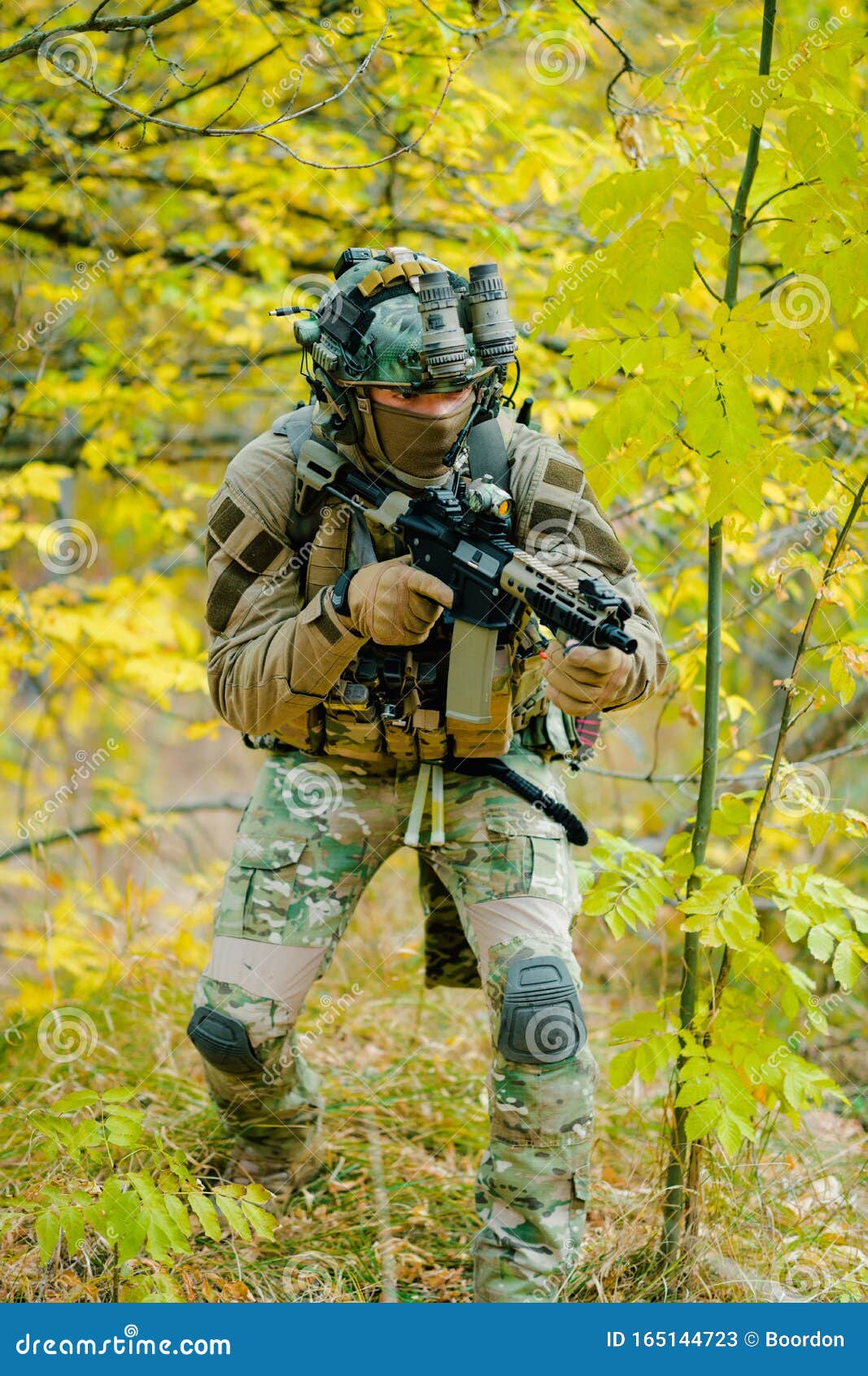 Airsoft Man in Uniform, Move with Machine Gun on Yellow Forest Backdrop ...