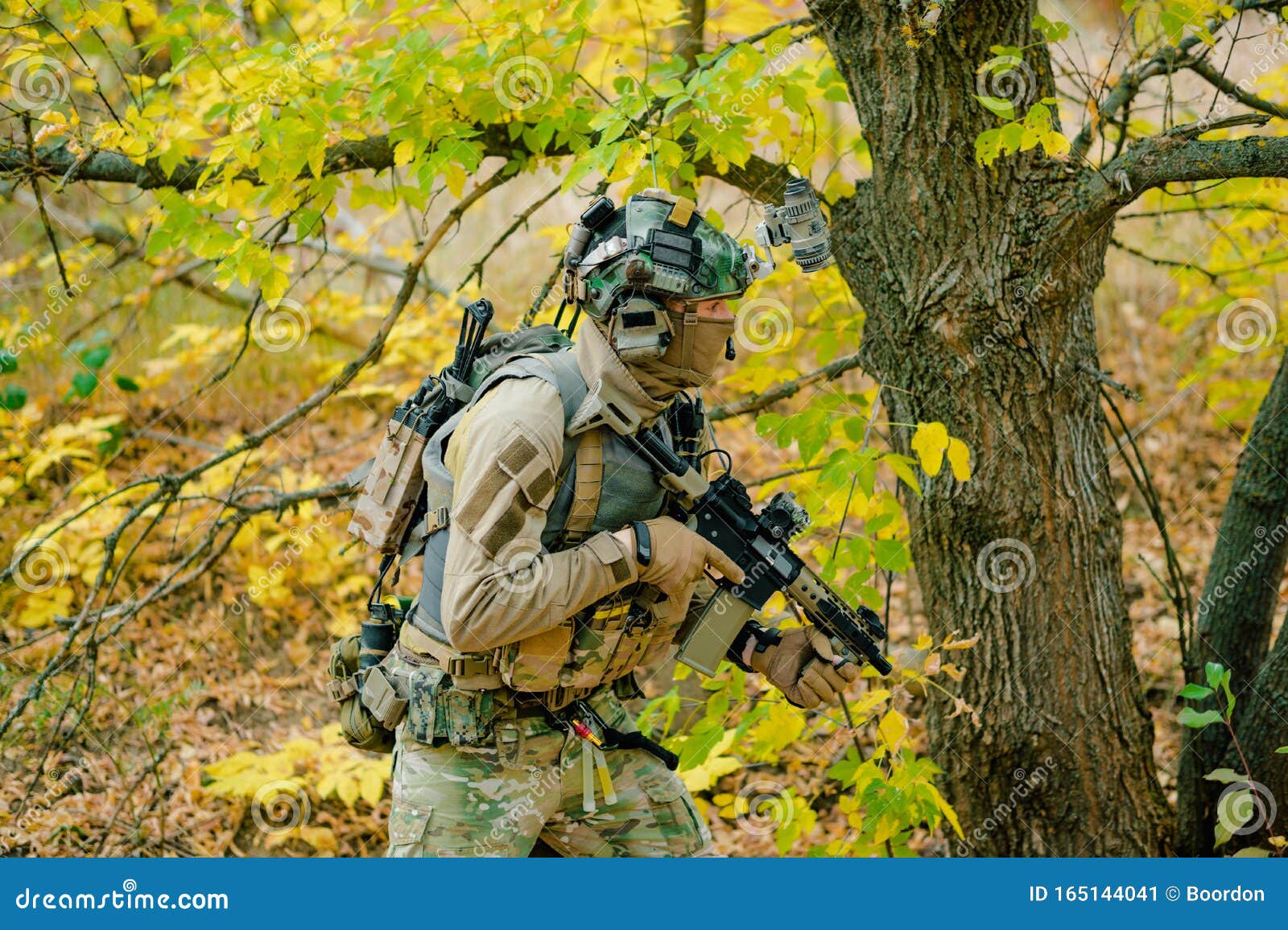 Airsoft Man in Uniform beside Tree Move with Machine Gun. Side View ...